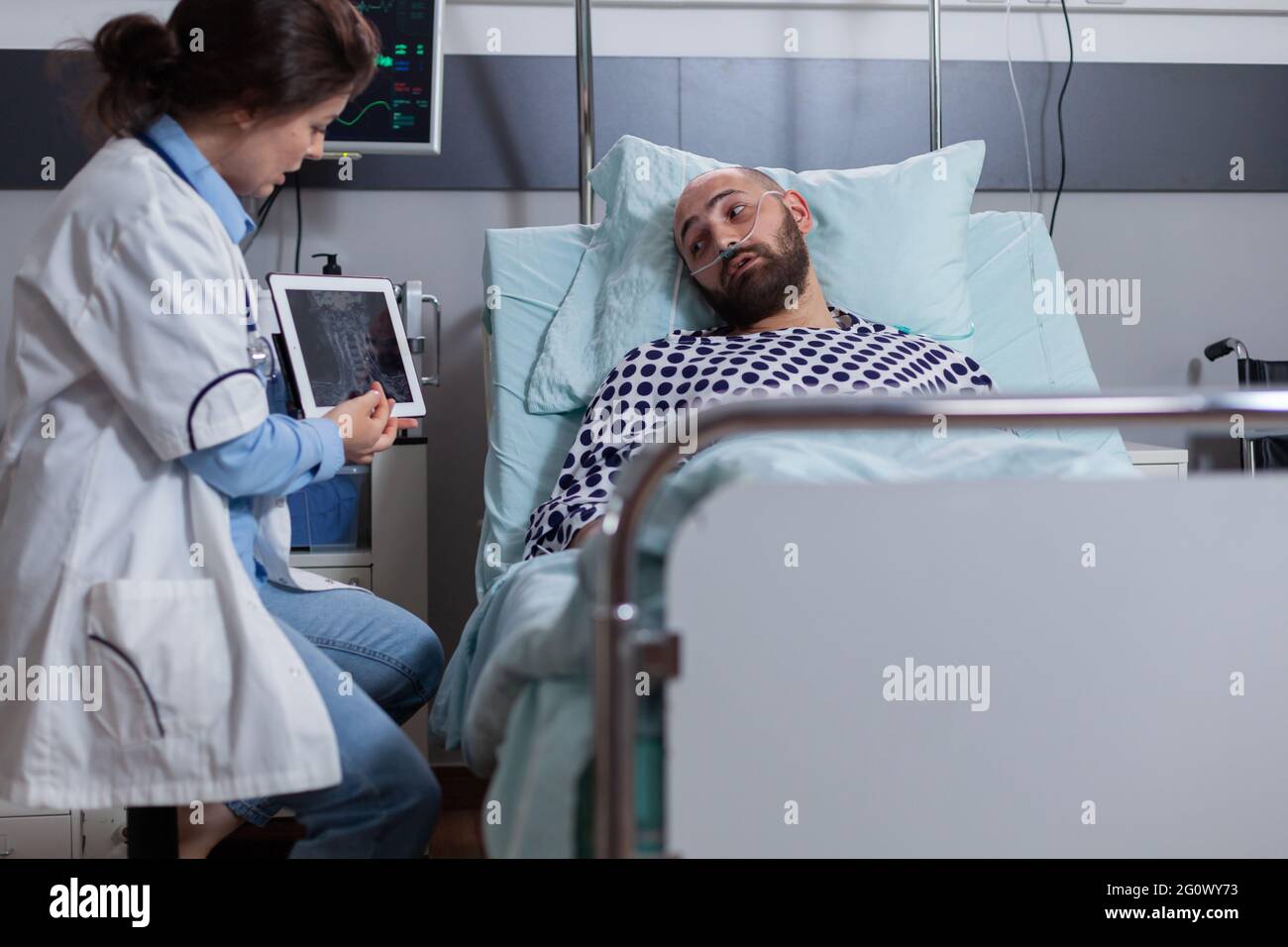 Physician doctor woman in medical uniform explaining bones radiography ...