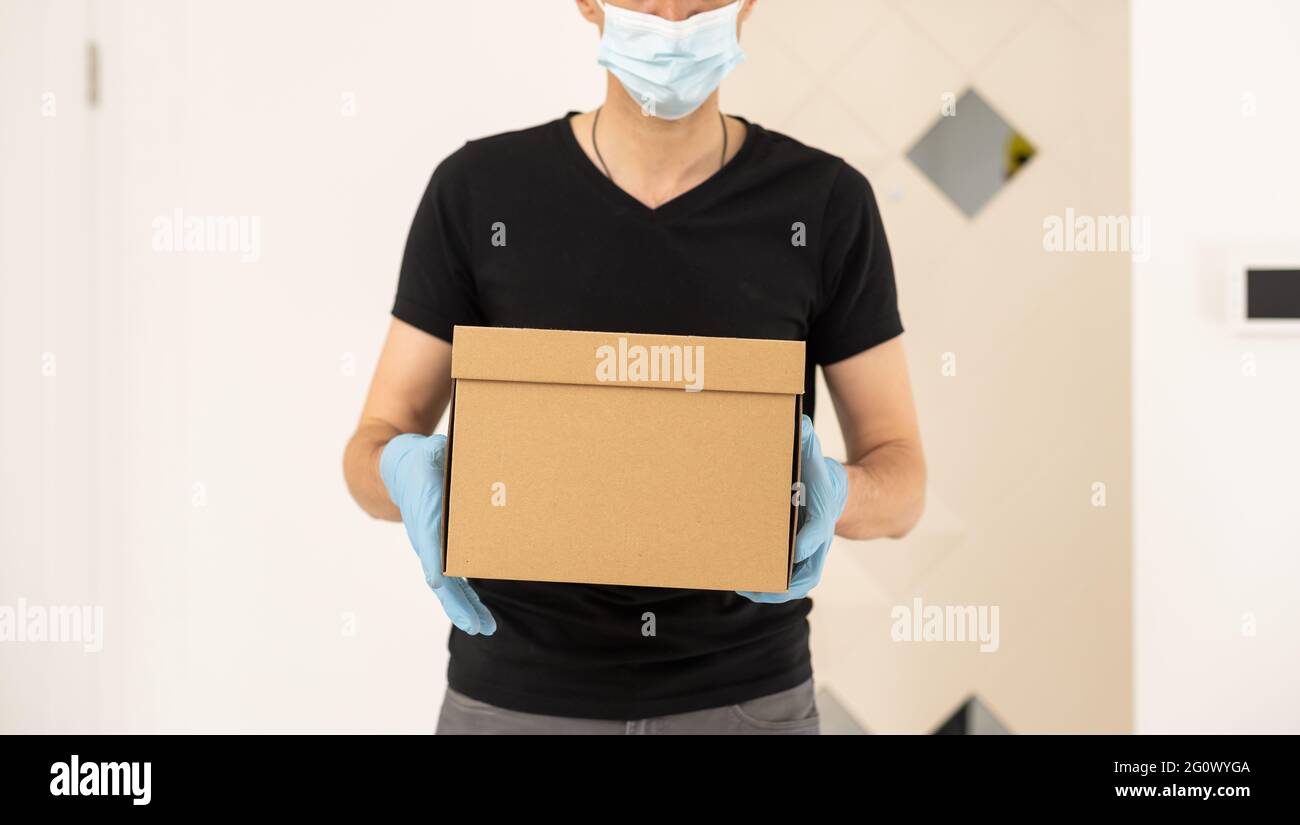 Closeup hands of delivery man holding package to deliver. Courier hand ...