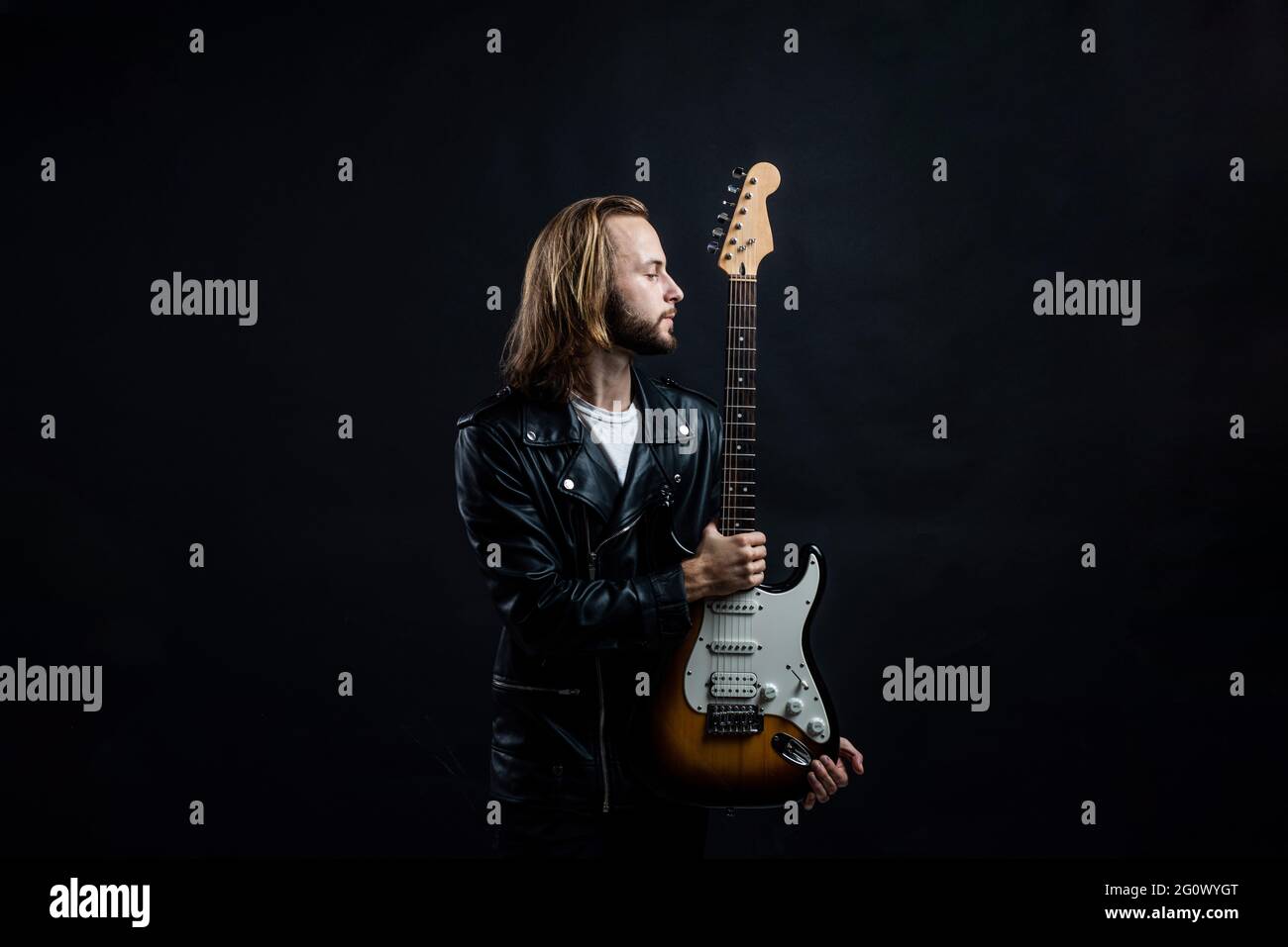 rock music style star. musician guitar player. masterfully playing rock ...