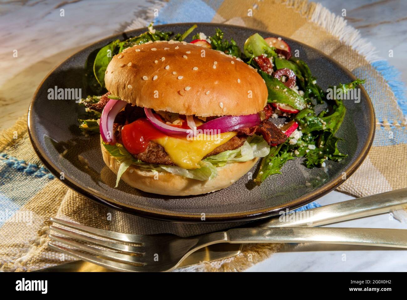 Angus beef cheeseburger topped with crispy bacon served with a side ...