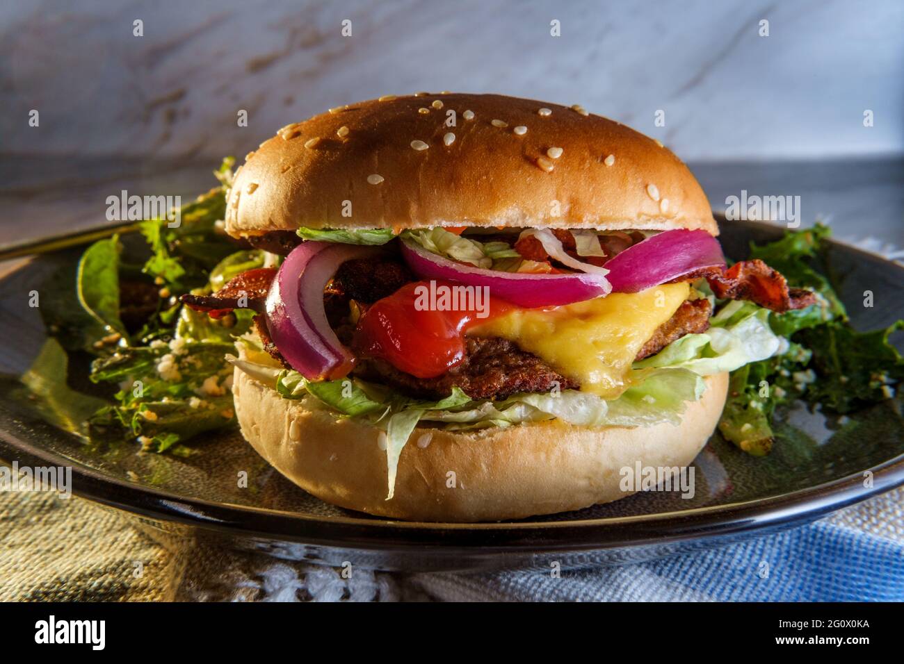 Angus beef cheeseburger topped with crispy bacon served with a side ...