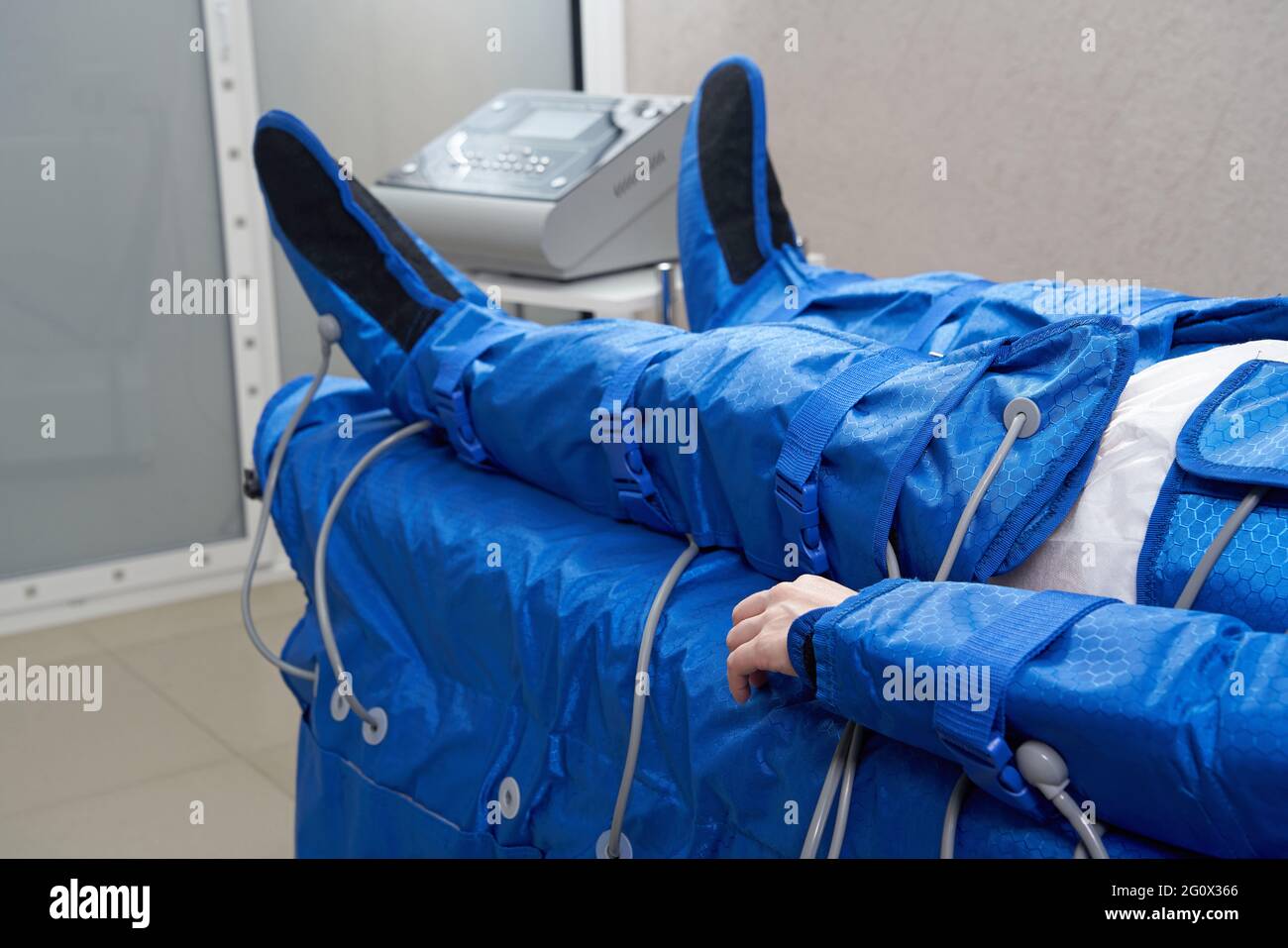 woman receiving the procedure of pressure therapy to make her legs ...