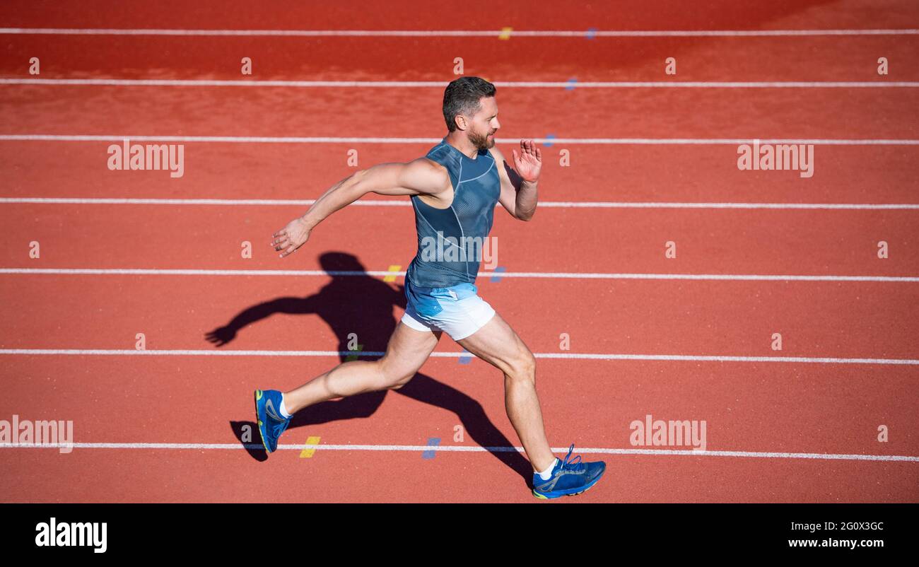 marathon speed. sprinter. energetic man on running track. sporty runner ...