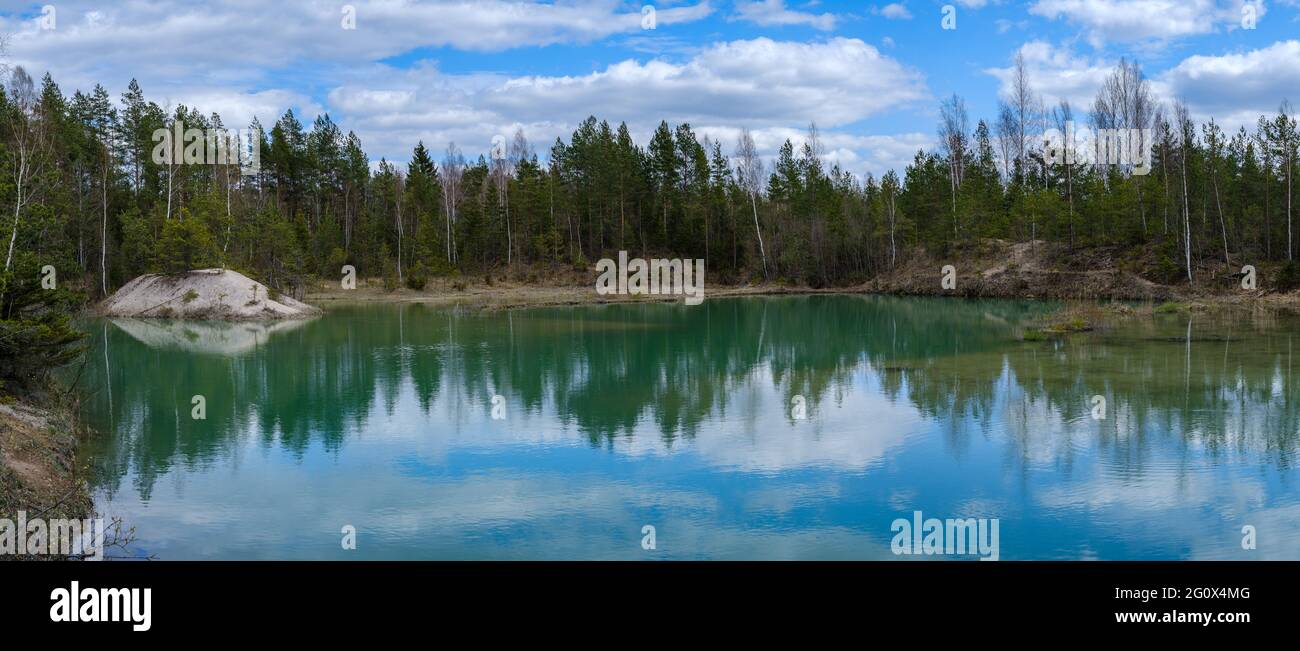 small rural pond with grass and reflections in water in summer Stock ...