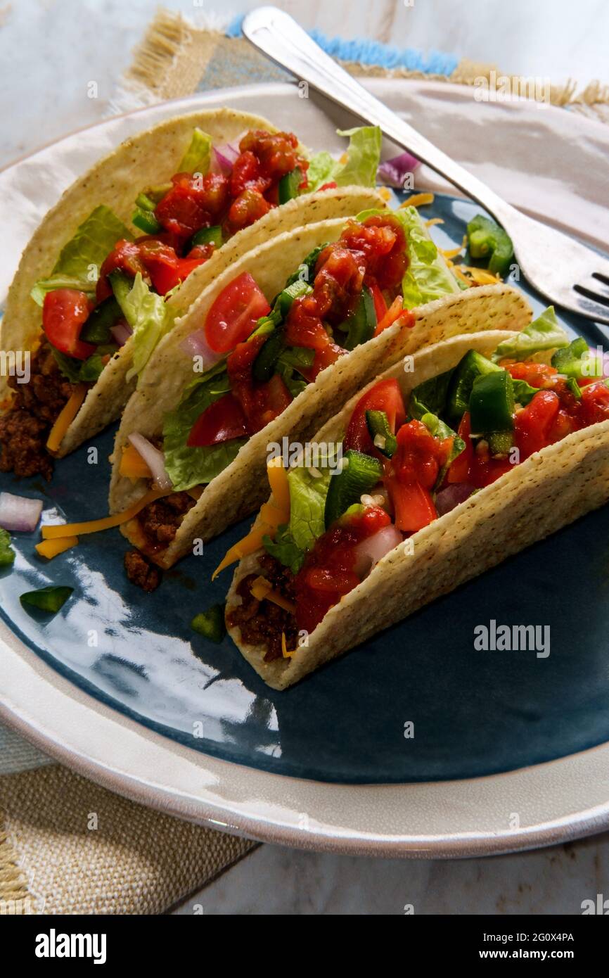 Mexican beef tacos with romaine lettuce cheddar cheese red onions and ...