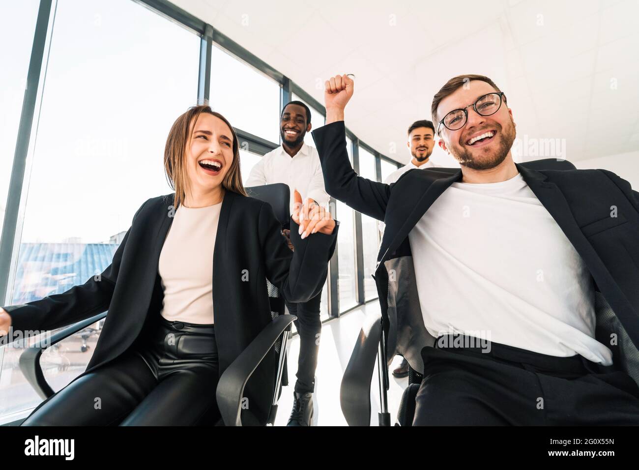 Joyful employees ride on hi-res stock photography and images - Alamy
