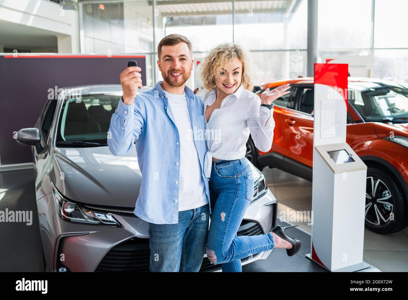 Young couple standing car dealership hi-res stock photography and ...