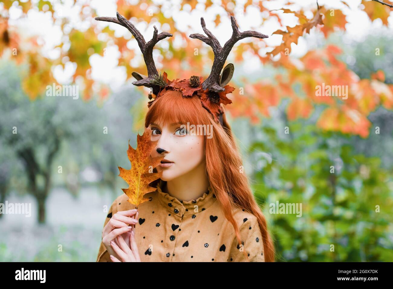 fairy woman with deer horns in autumn forest. Face painting. Beautiful ...