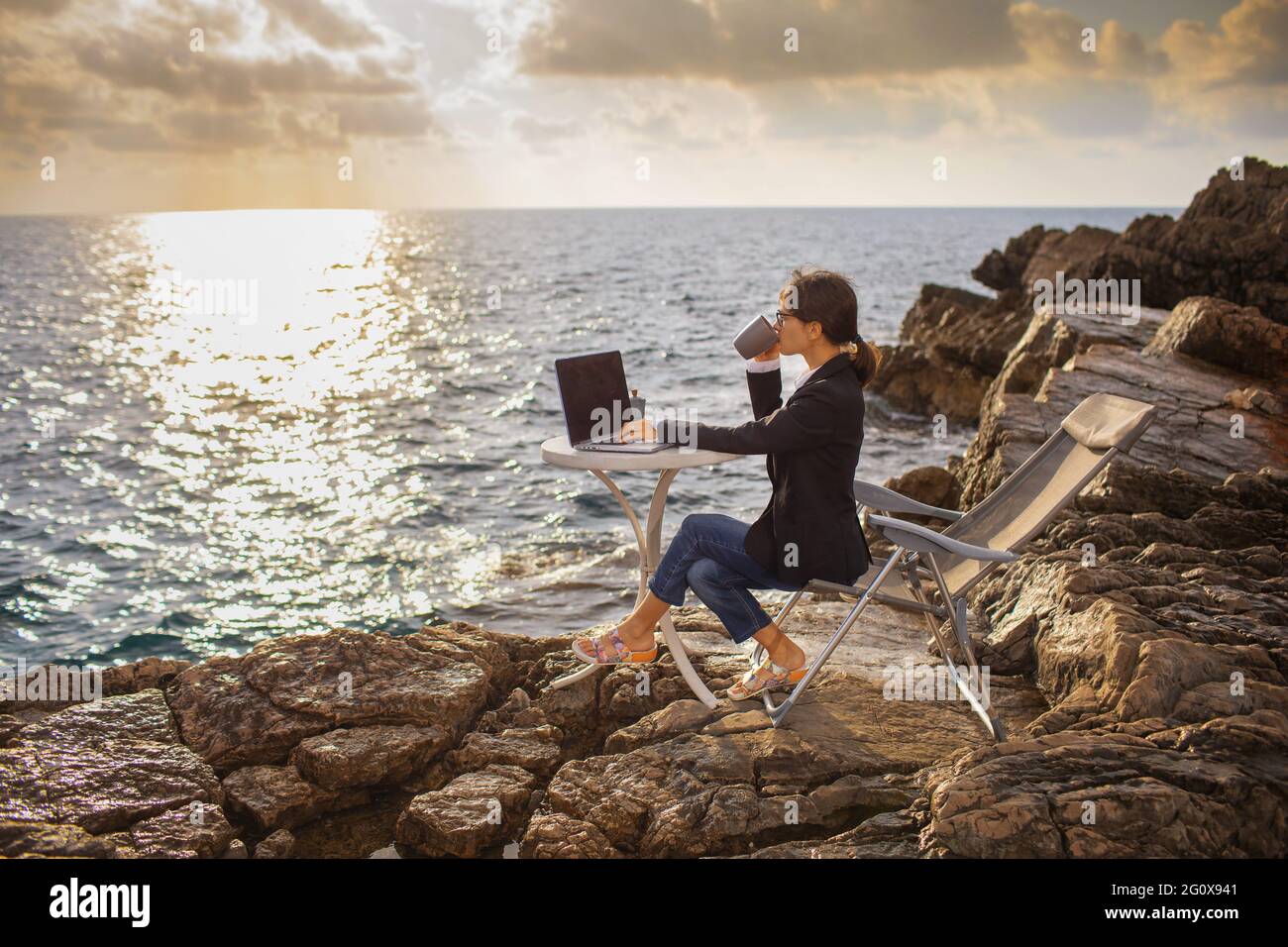 Business woman working from the beach. Working from distance concept ...