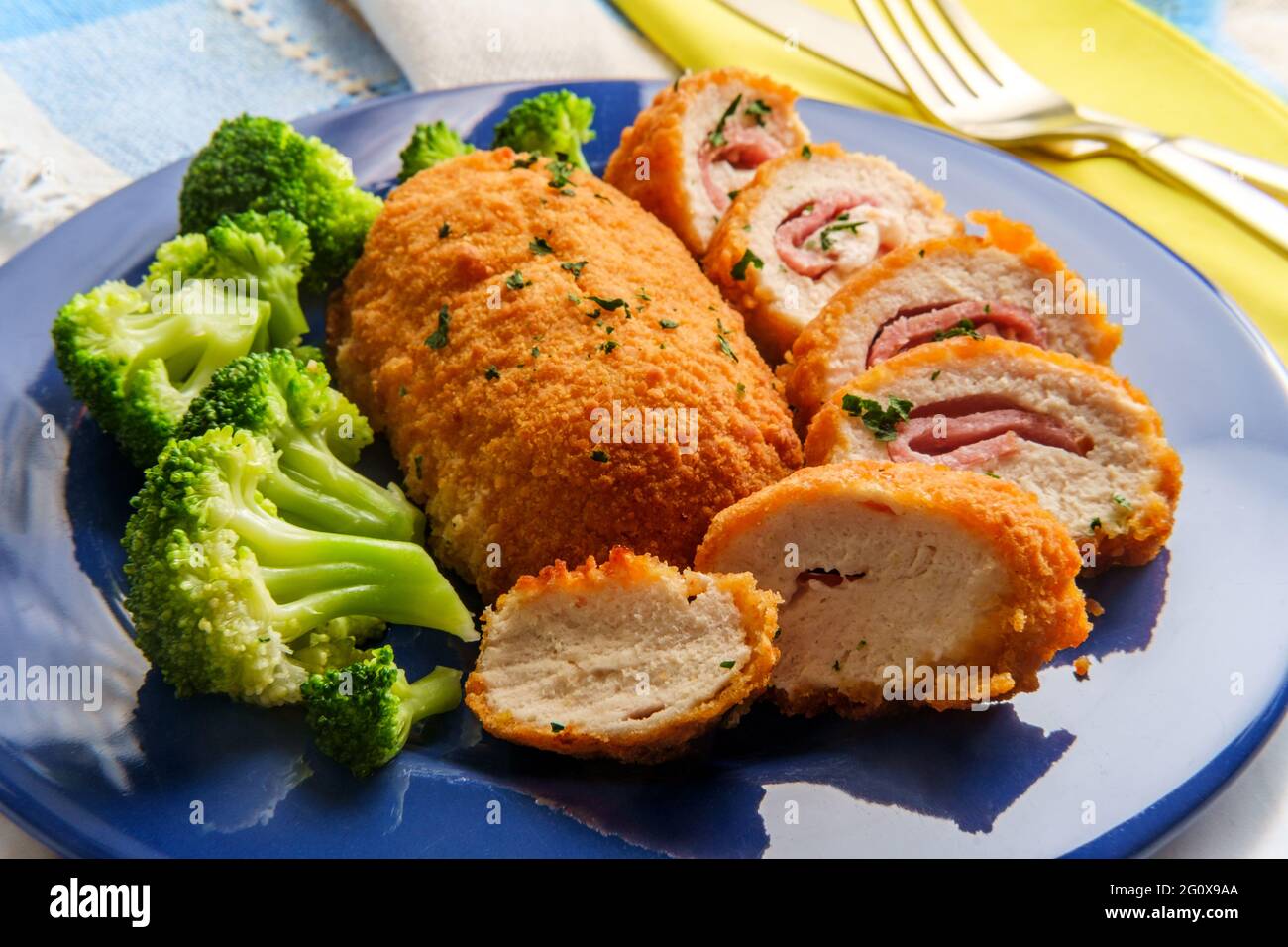 Chicken cordon bleu served with steamed broccoli Stock Photo - Alamy