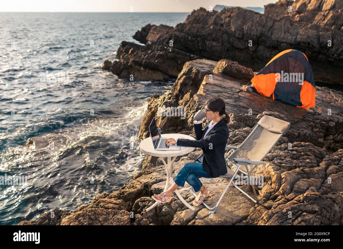 Business woman working from the beach. Working from distance concept ...