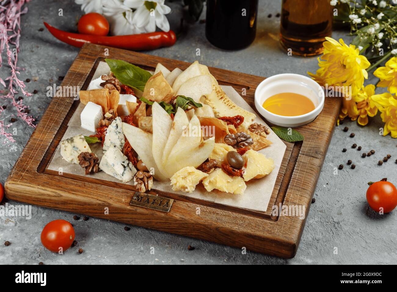 Palette of many types of cheese and some grapes, olives Stock Photo - Alamy