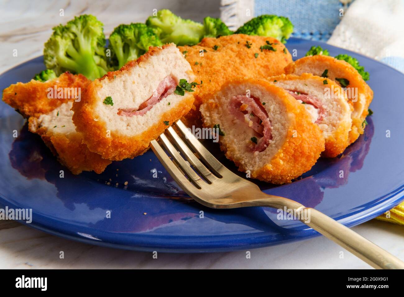 Chicken cordon bleu served with steamed broccoli Stock Photo - Alamy