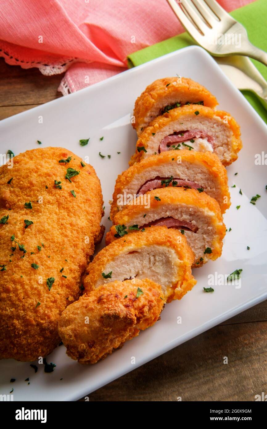 Chicken cordon bleu served with steamed broccoli Stock Photo - Alamy