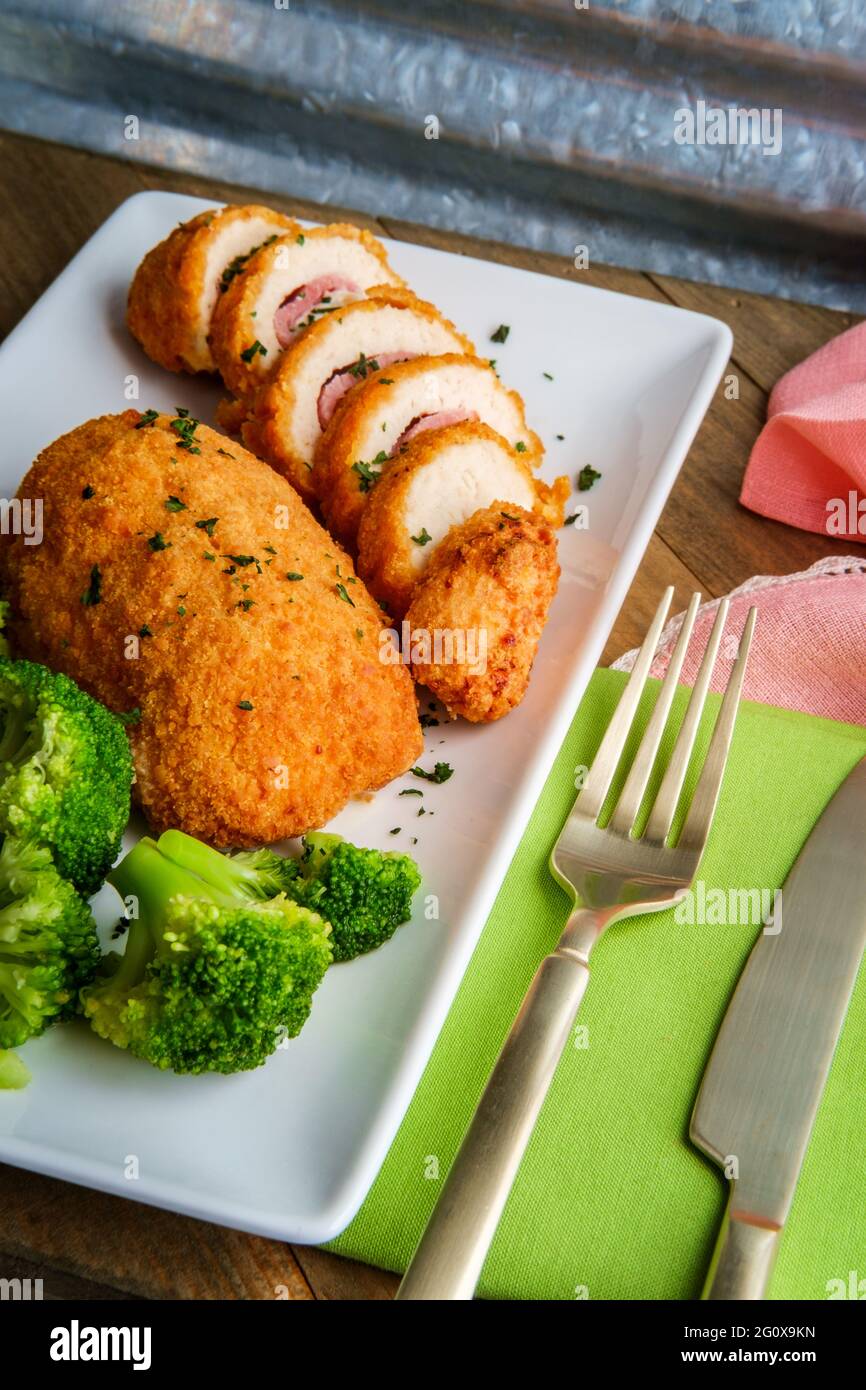 Chicken cordon bleu served with steamed broccoli Stock Photo - Alamy