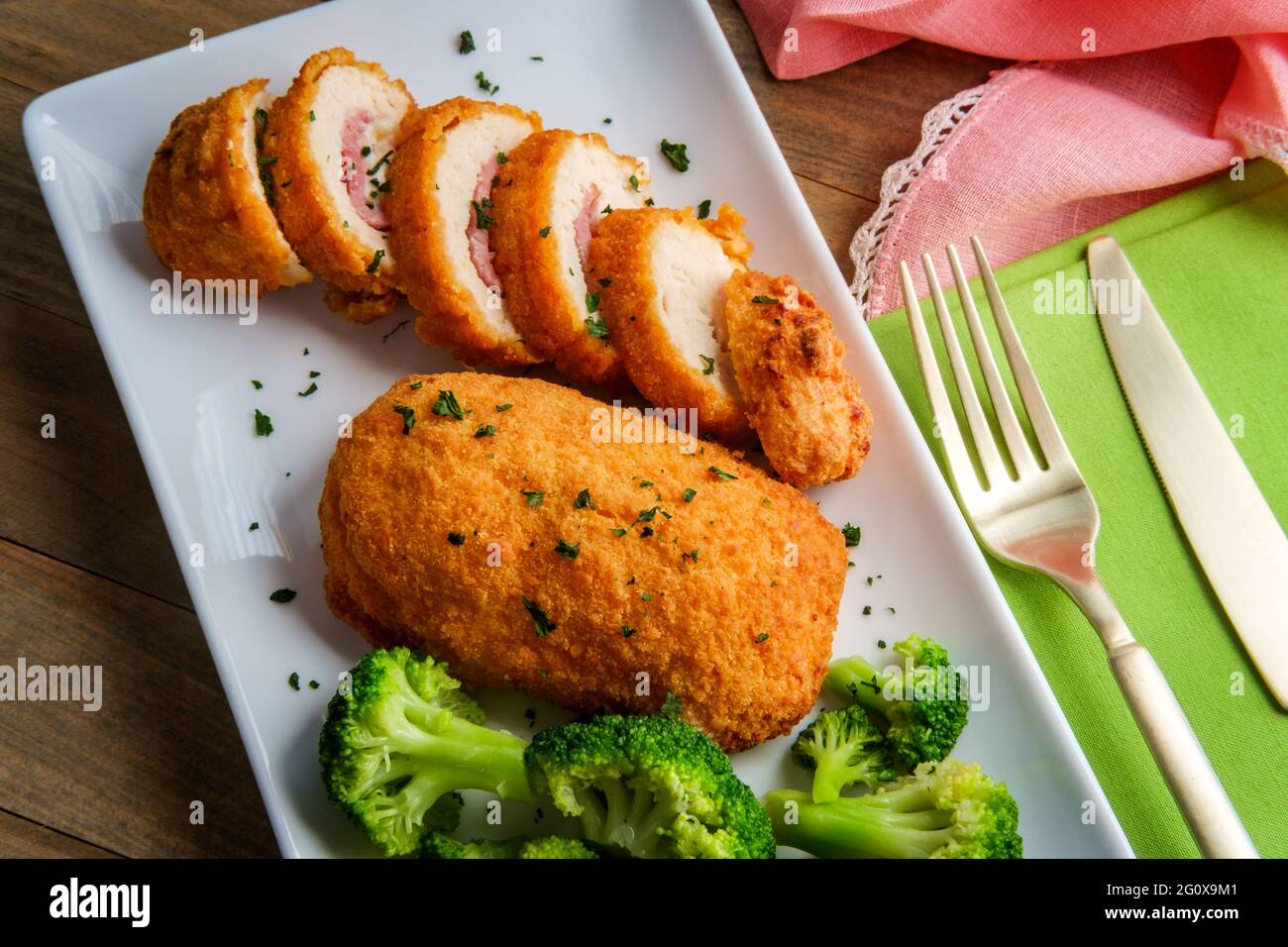 Chicken cordon bleu served with steamed broccoli Stock Photo - Alamy