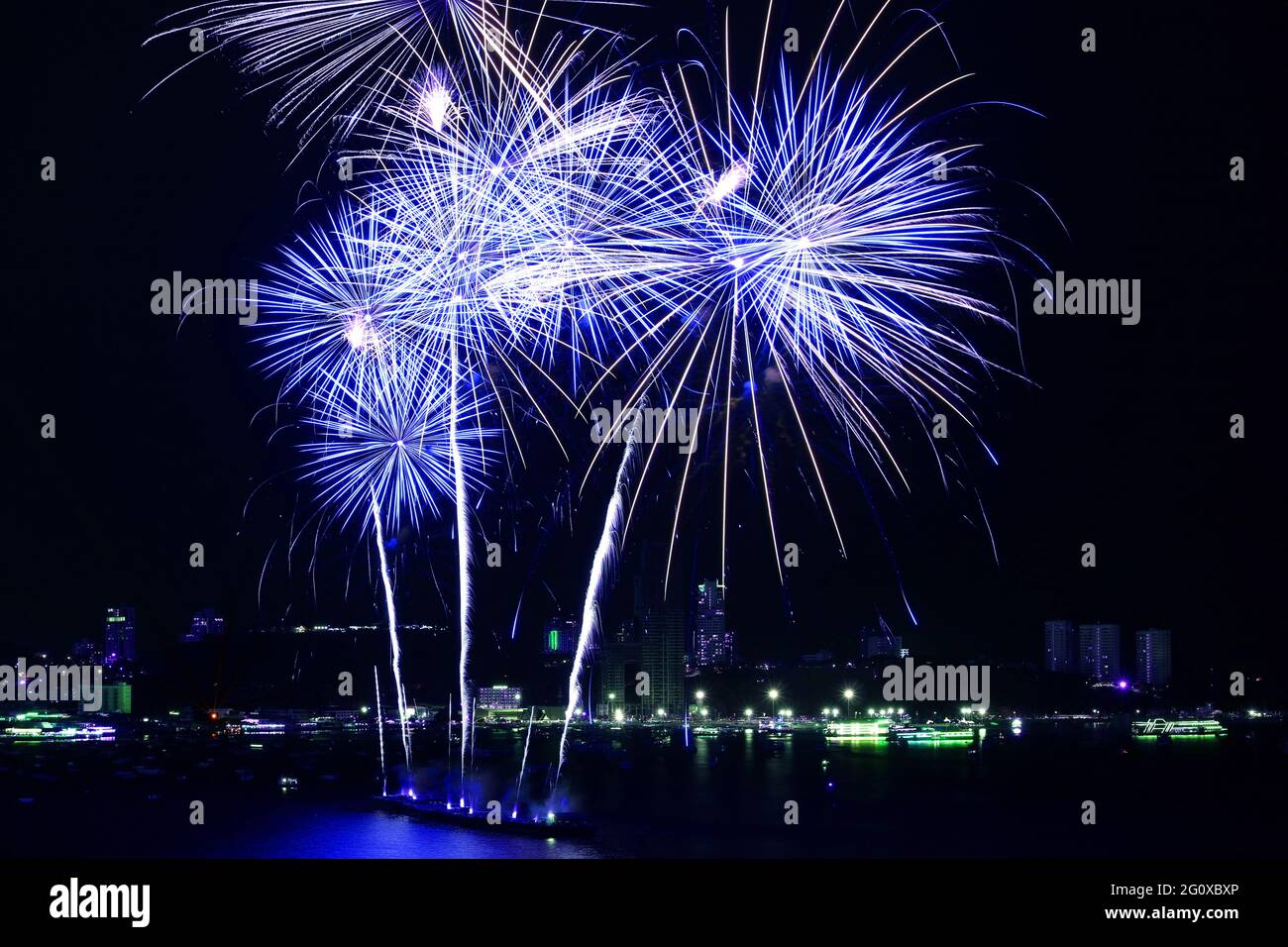 Stunning blue and white fireworks exploding into the night sky over the ...
