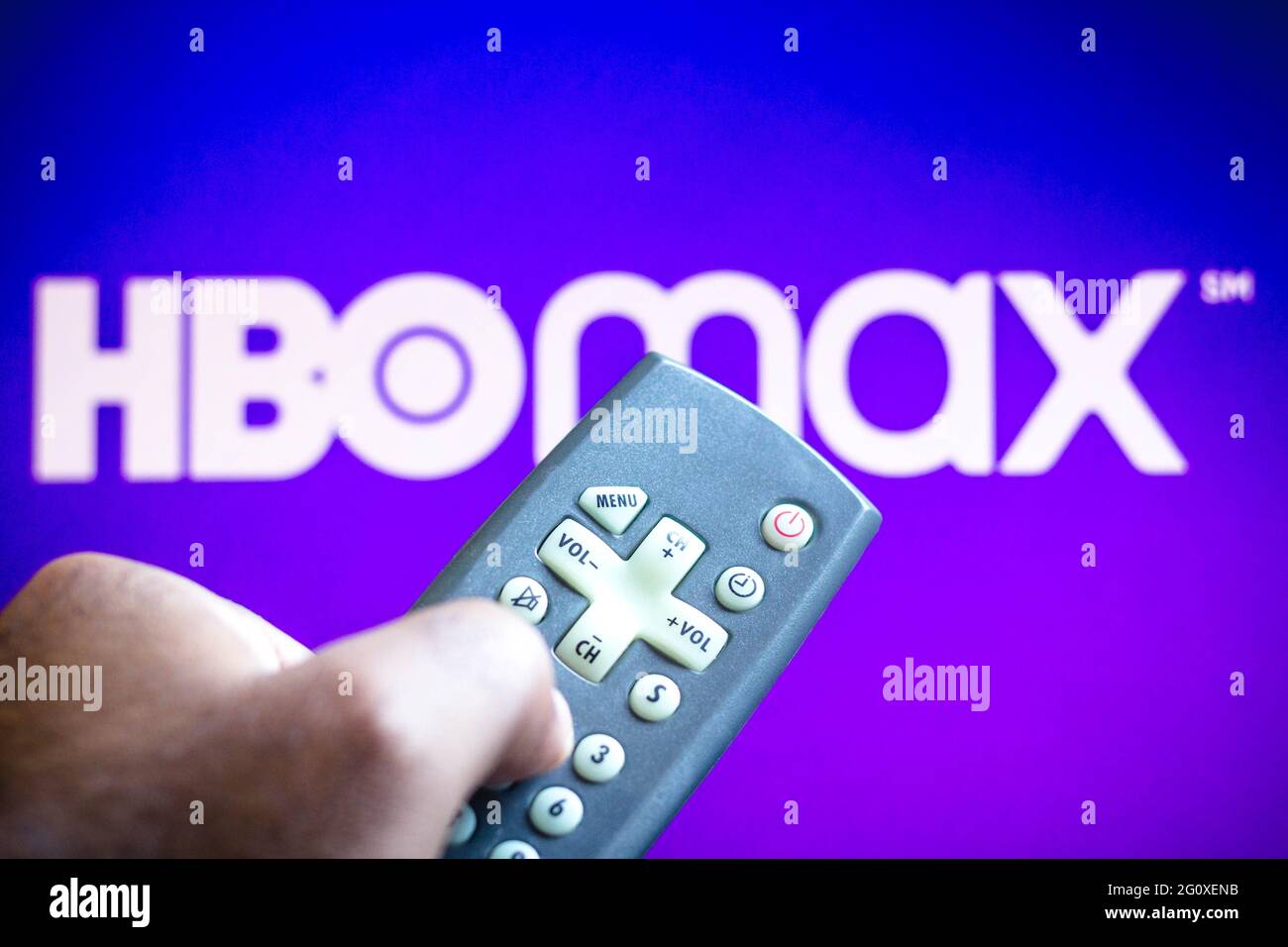 In this photo illustration a person holding a TV remote control and the ...