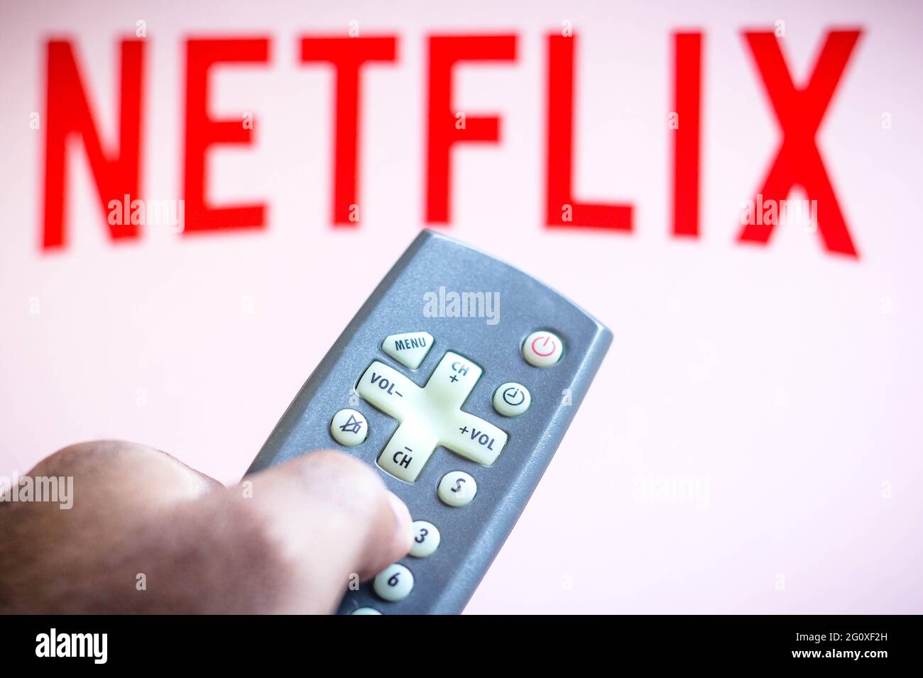 In this photo illustration a person holding a TV remote control and the ...