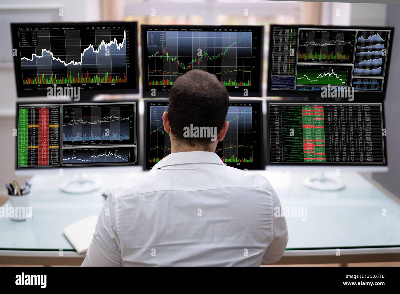 Stock Trader Man Using Multiple Computer Monitors Stock Photo - Alamy