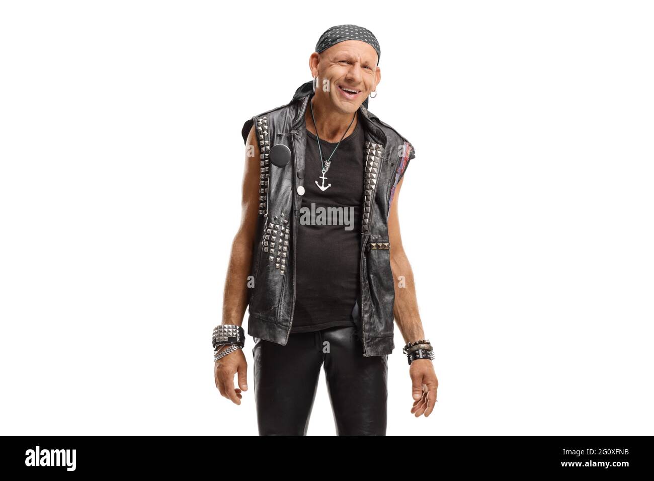 Cheerful punk in a leather outfit smiling at the camera isolated on ...