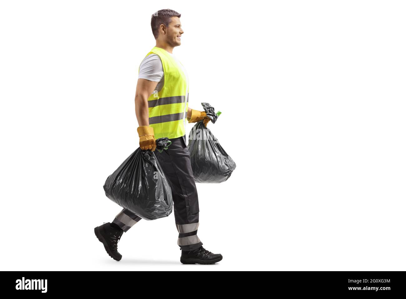 Full length profile shot of a waste collector in a uniform and gloves ...