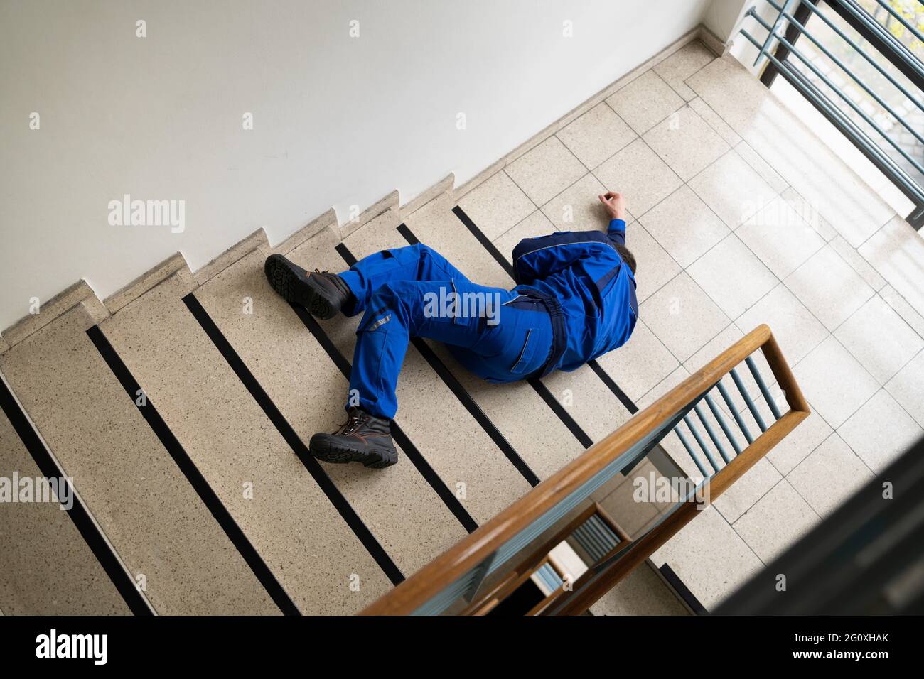 Worker Man Lying On Staircase After Slip And Fall Accident Stock Photo ...