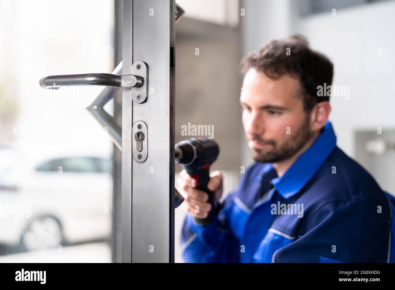 Locksmith Man Repairing And Changing Metal Door Lock Stock Photo - Alamy