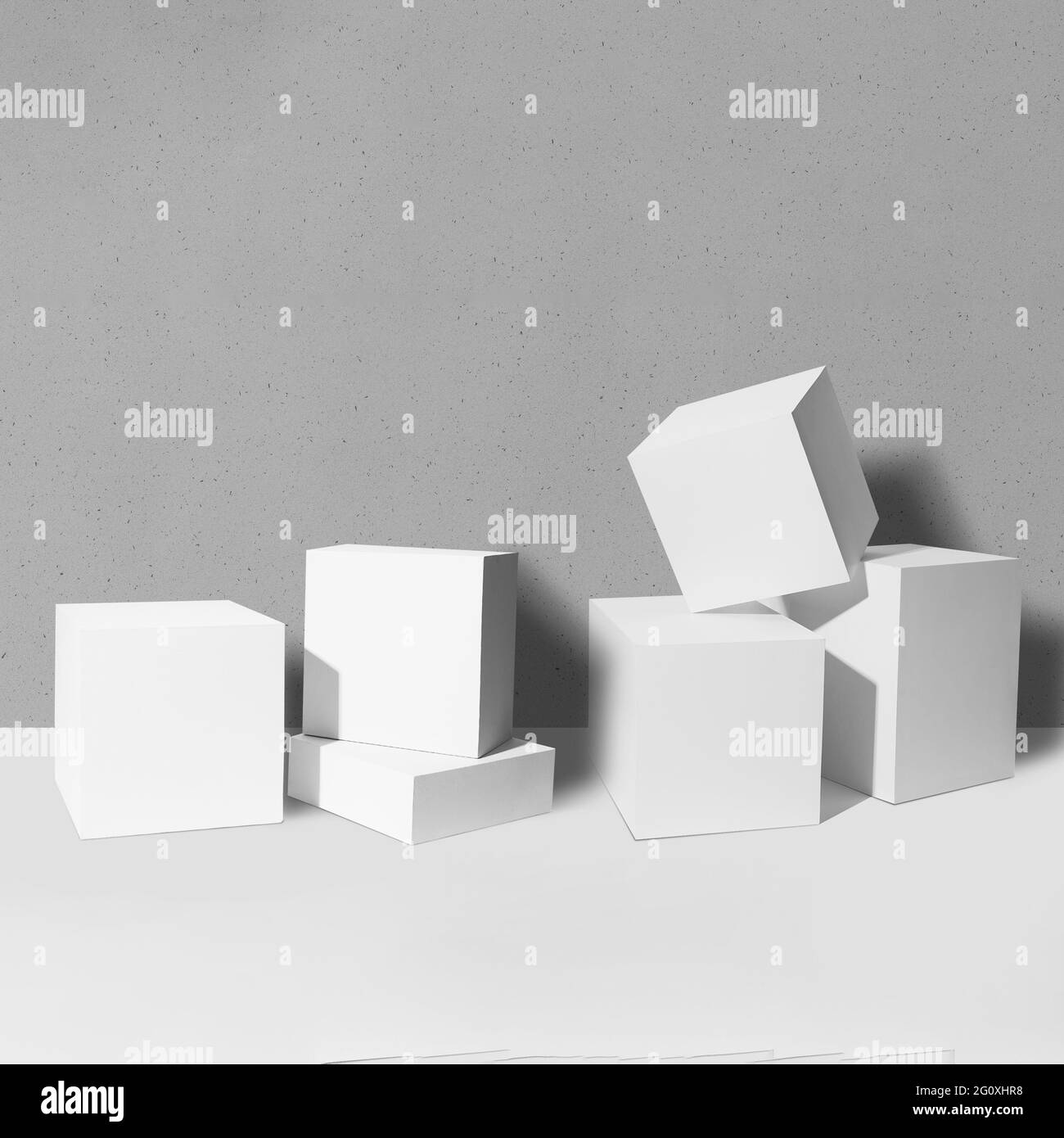3D rendering of white empty cubes with mockup against a gray background ...