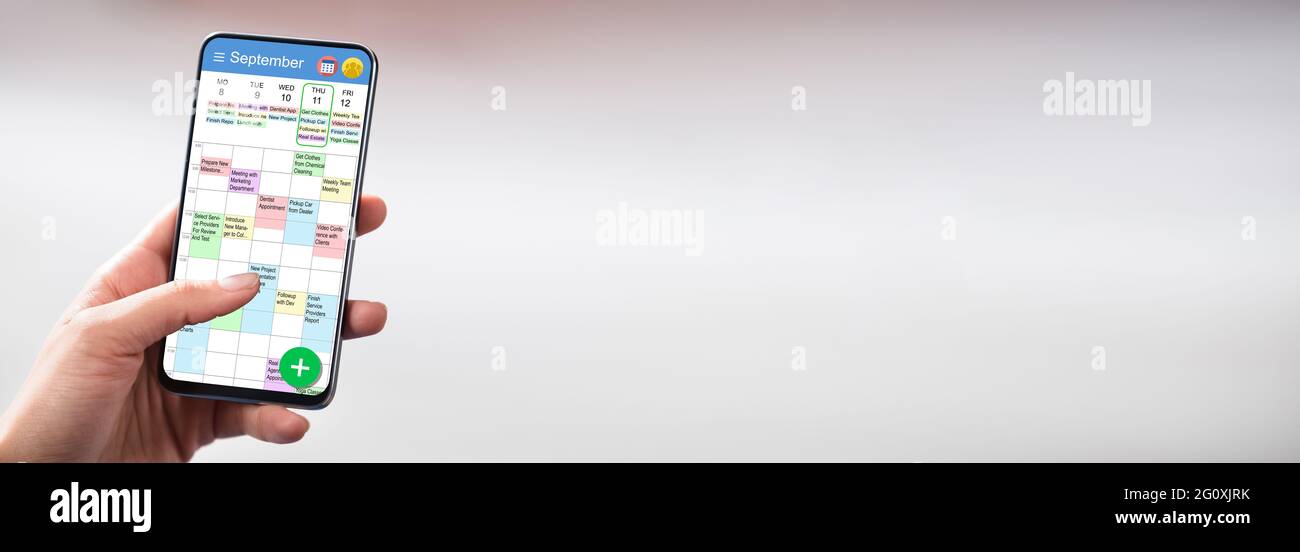 Executive Looking At Calendar On Mobile Phone. Arranging Weekly ...