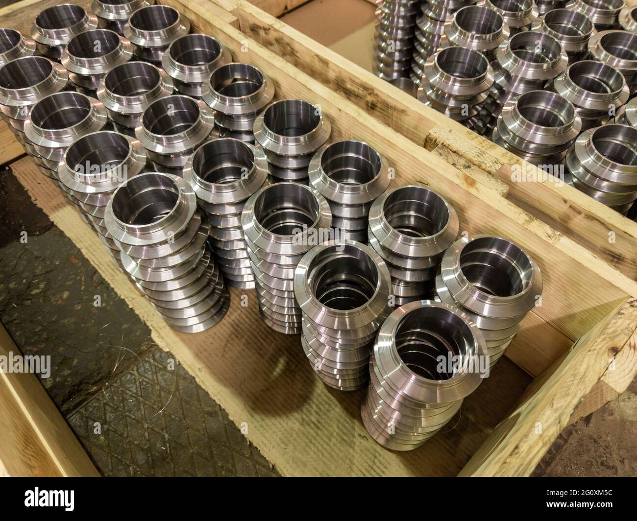 stacks of batch production round parts in a wooden boxes on factory ...