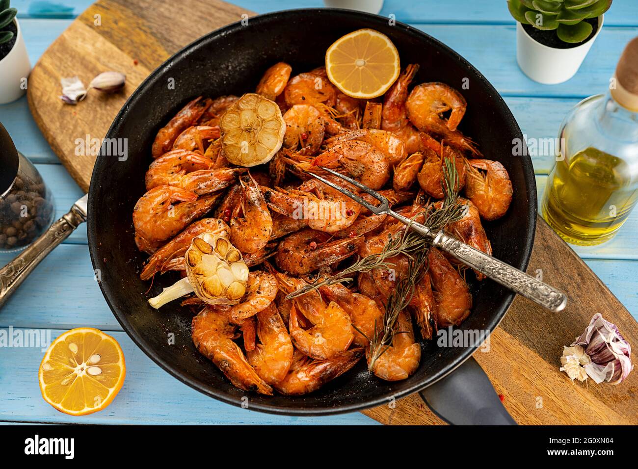 Fried unpeeled shrimp. Served in a rustic-style frying pan. Roasted ...