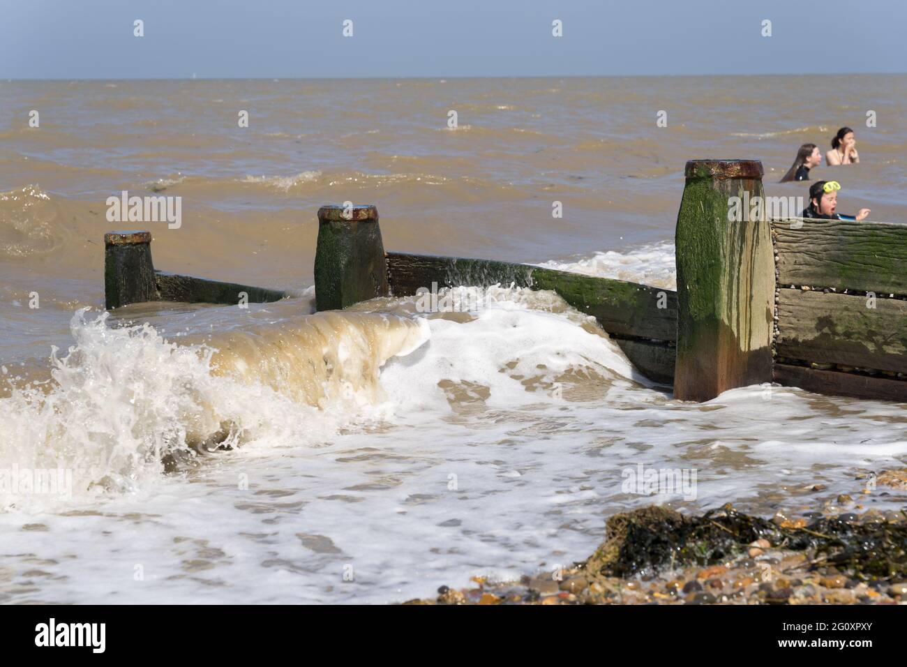 Groups of woman playing in tidal wave in the sea , Sheppey beach, Kent ...