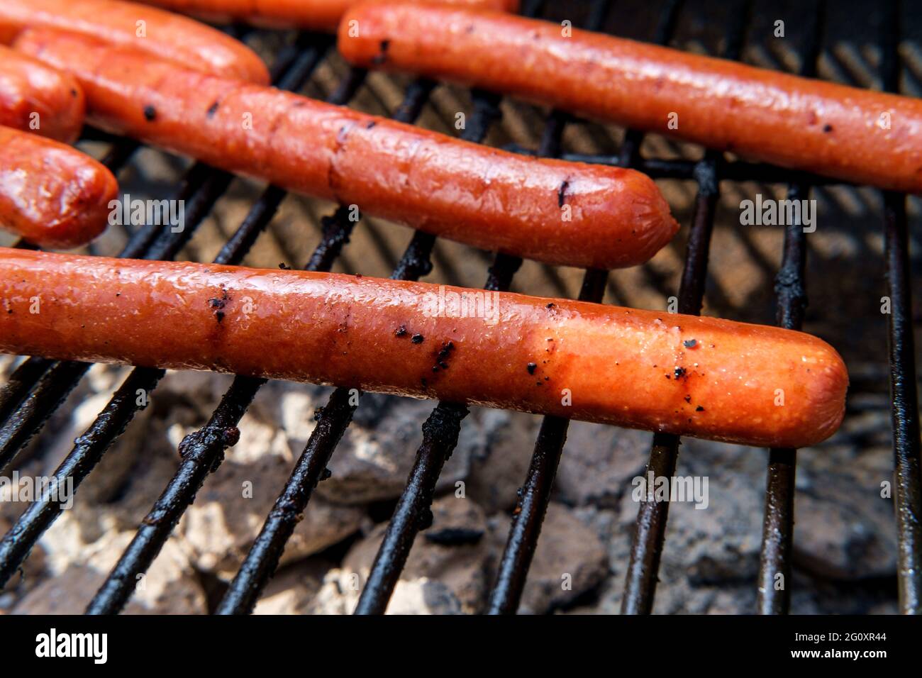 Grilling foot long hotdogs for summer barbecue picnic Stock Photo - Alamy