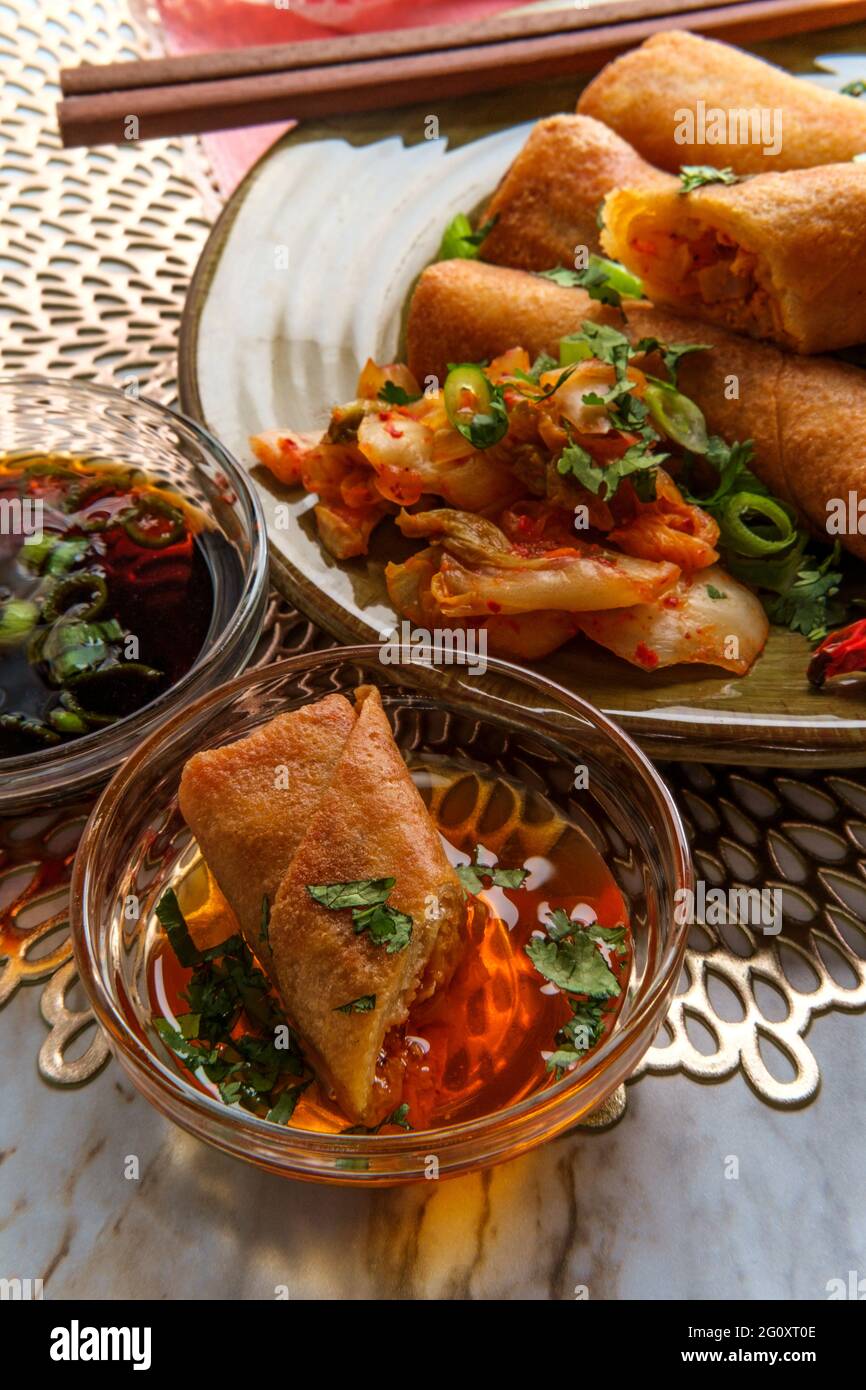Deep fried dim sum Chinese kimchi spring rolls with dipping sauces ...