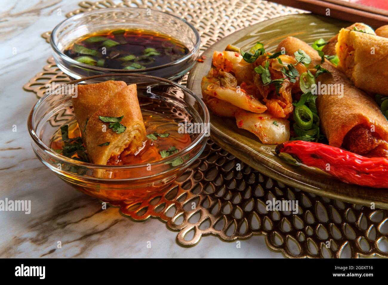 Deep fried dim sum Chinese kimchi spring rolls with dipping sauces ...