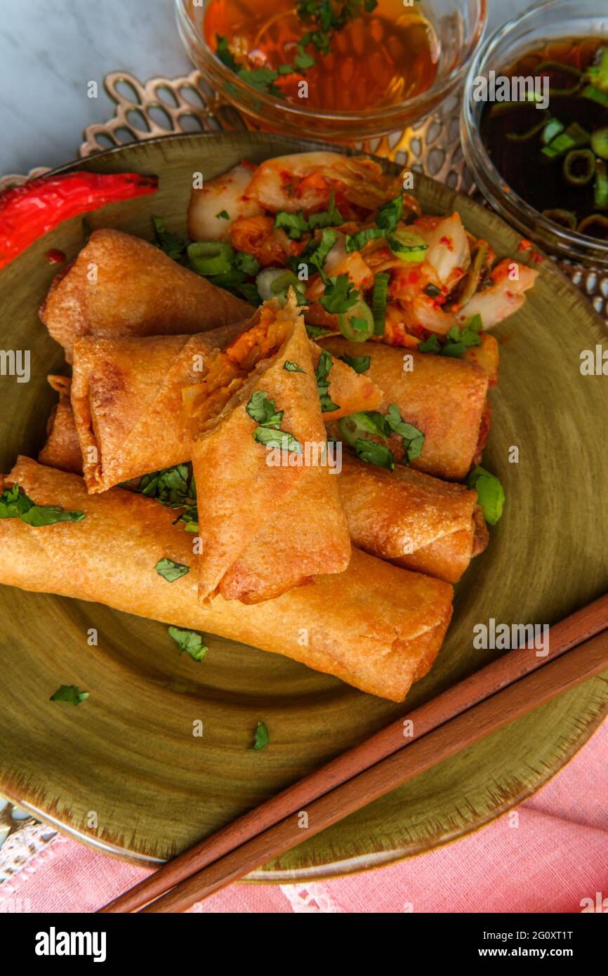 Deep fried dim sum Chinese kimchi spring rolls with dipping sauces ...