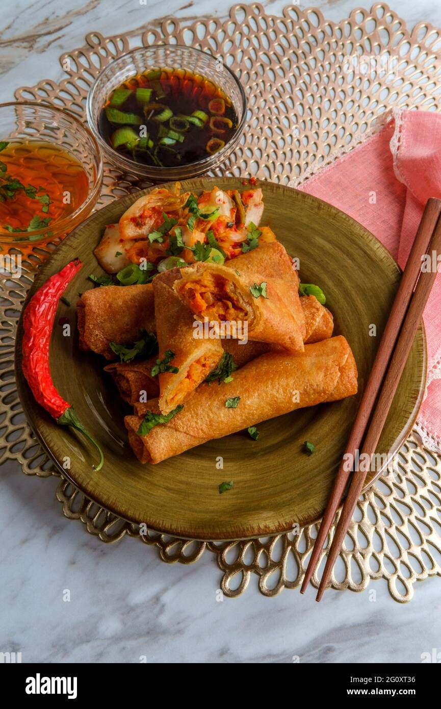 Deep fried dim sum Chinese kimchi spring rolls with dipping sauces ...