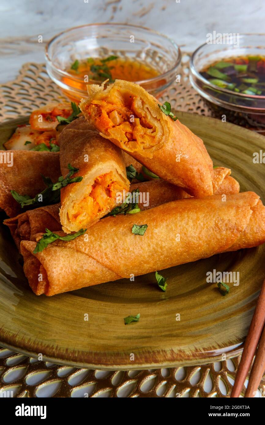 Deep fried dim sum Chinese kimchi spring rolls with dipping sauces ...