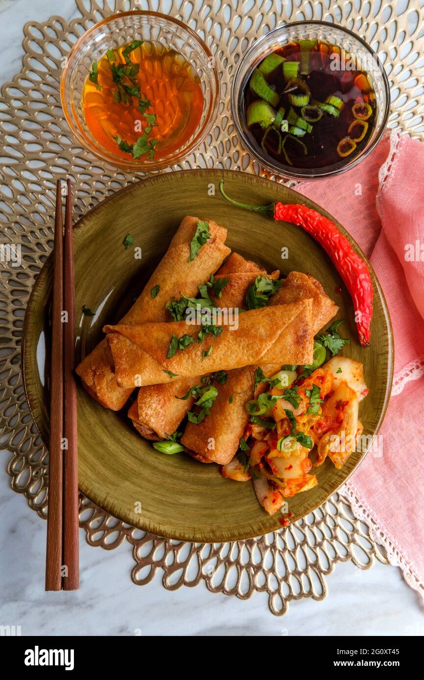 Deep fried dim sum Chinese kimchi spring rolls with dipping sauces ...