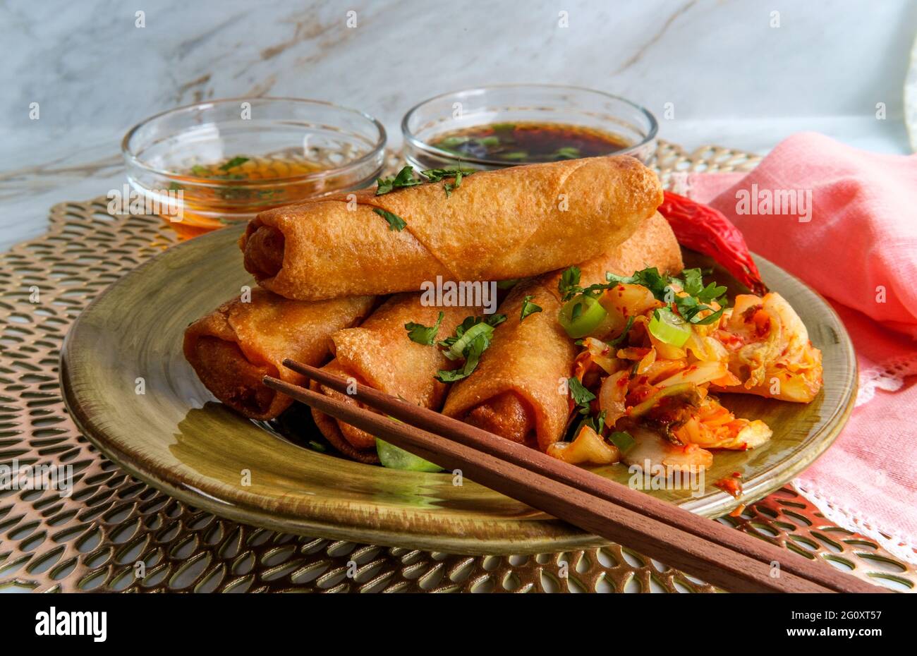 Deep fried dim sum Chinese kimchi spring rolls with dipping sauces ...