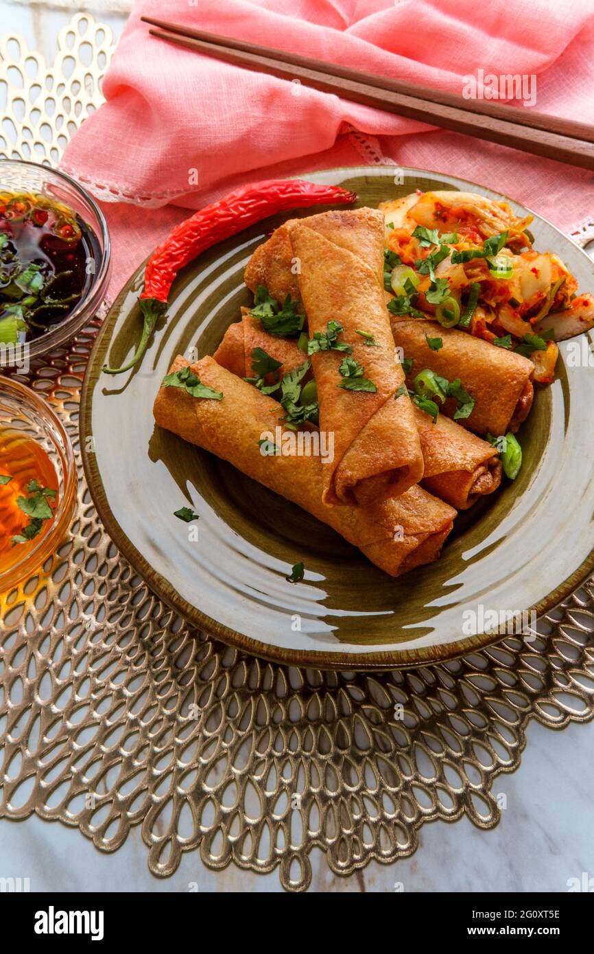 Deep fried dim sum Chinese kimchi spring rolls with dipping sauces ...