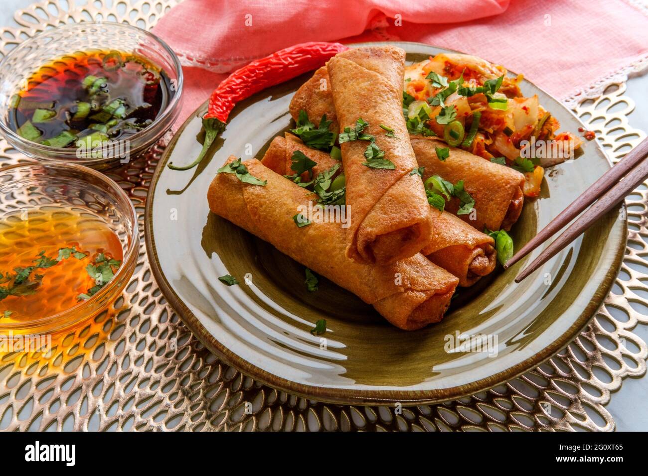 Deep fried dim sum Chinese kimchi spring rolls with dipping sauces ...