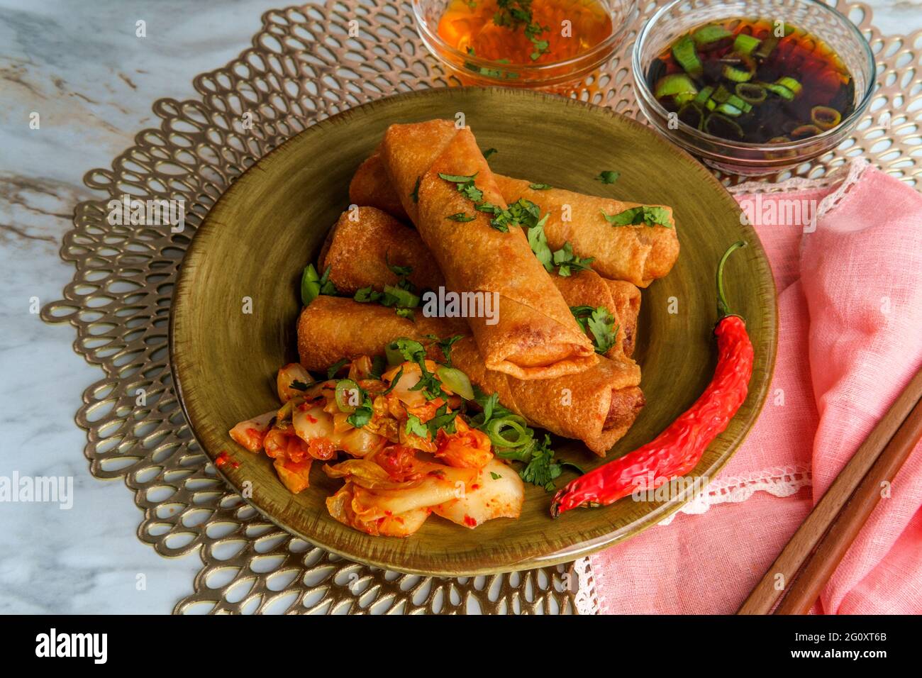Deep fried dim sum Chinese kimchi spring rolls with dipping sauces ...