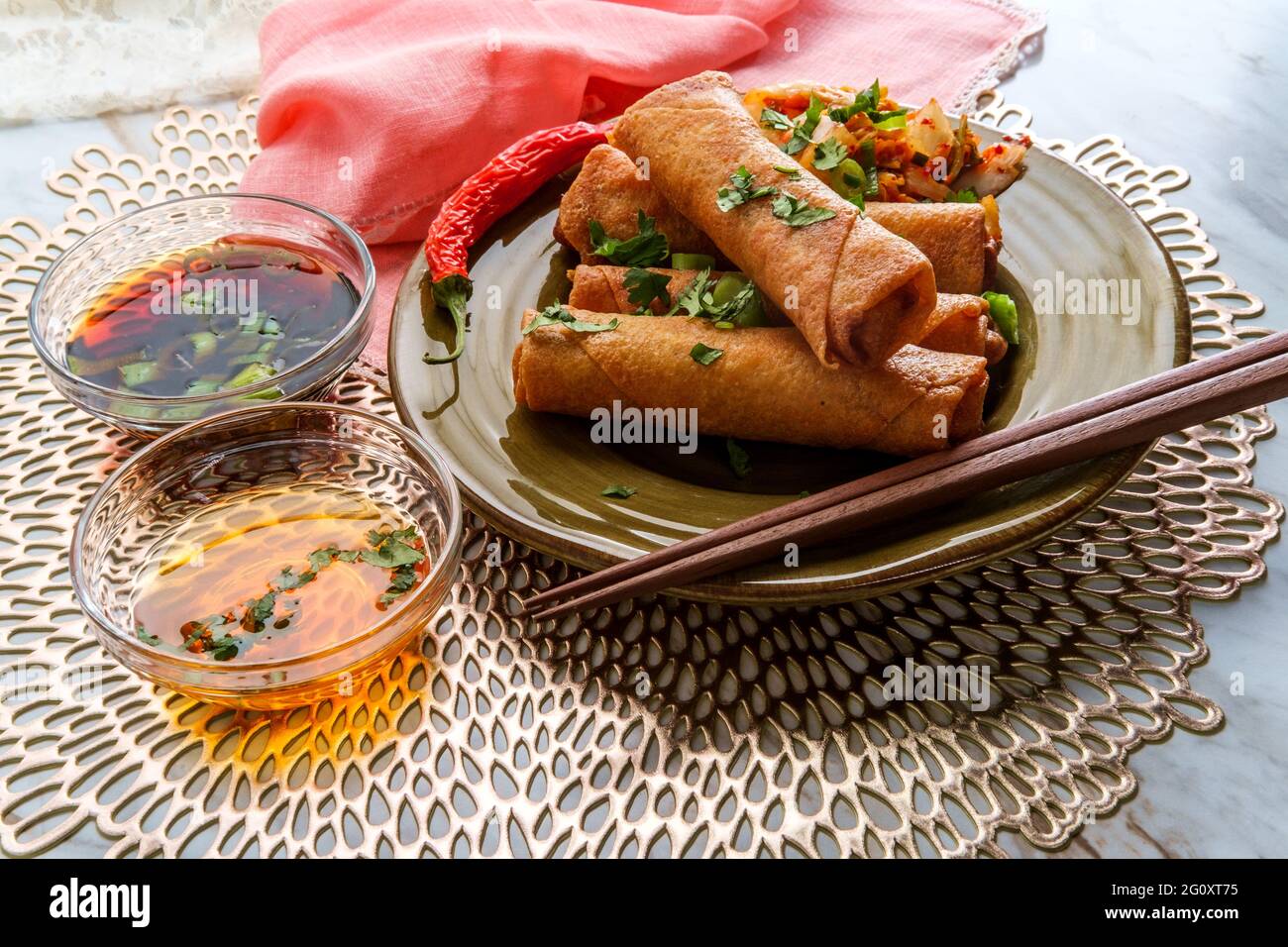 Deep fried dim sum Chinese kimchi spring rolls with dipping sauces ...