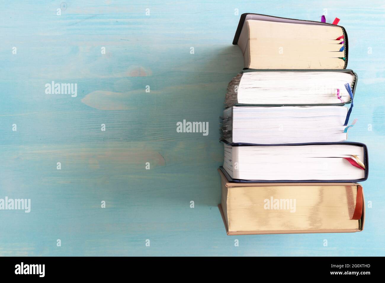 border of stack of books on blue wood background with copy space Stock ...