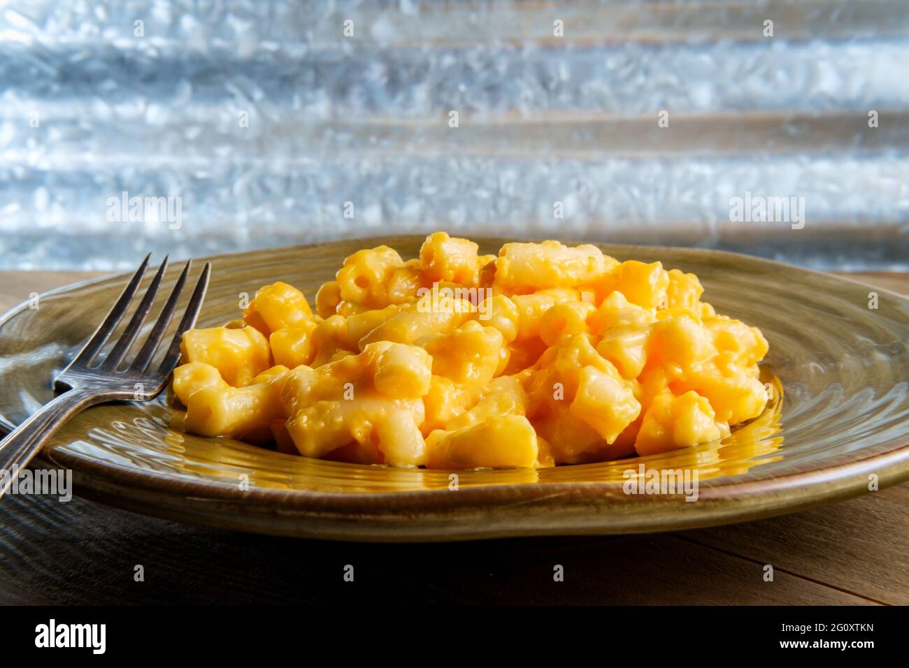 Delicious macaroni and cheese on wooden table with dramatic dark and moody lighting Stock Photo ...