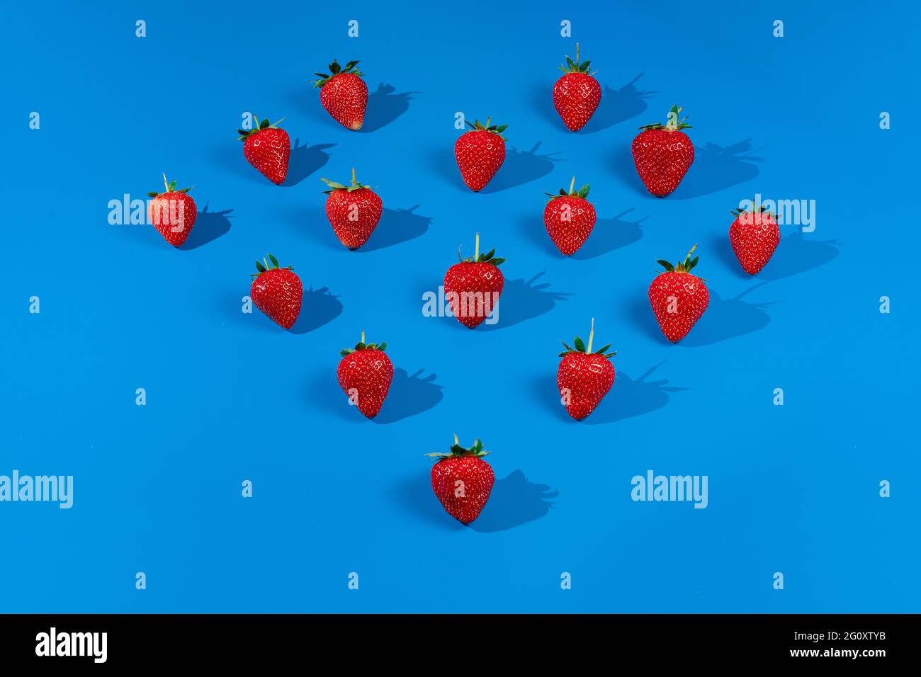 Red strawberries on blue background. Ripe tasty berry Stock Photo - Alamy