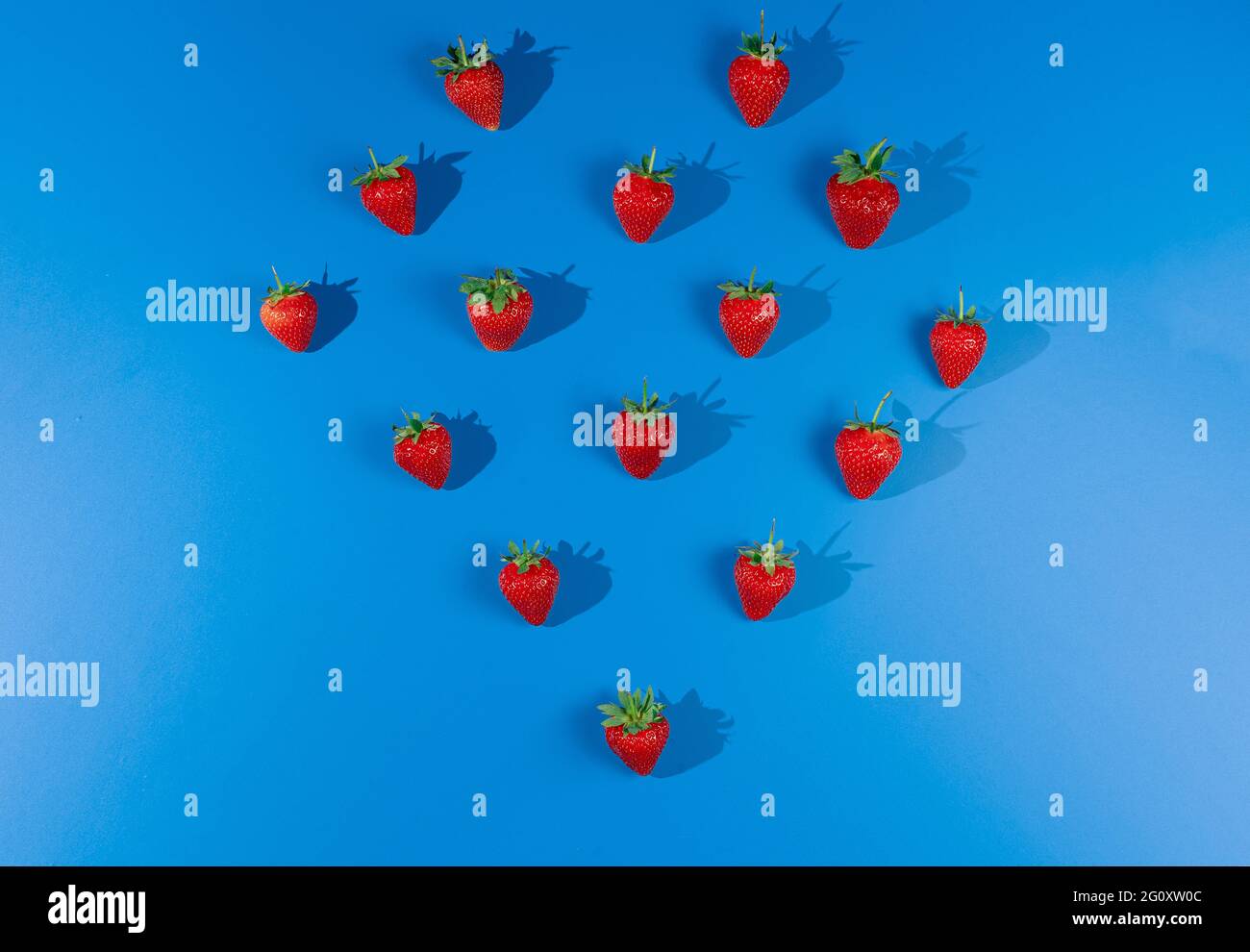 Red strawberries on blue background. Ripe tasty berry Stock Photo - Alamy