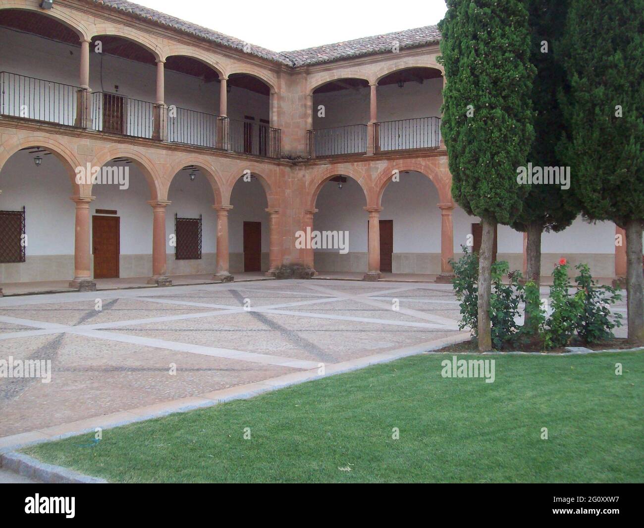 Two-story building with arches and columns and a big garden Stock Photo ...